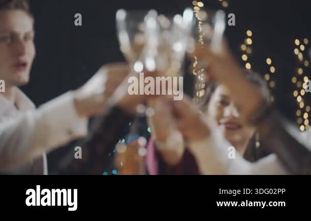 Close up of happy faces of young friends having rest together, clinking ...