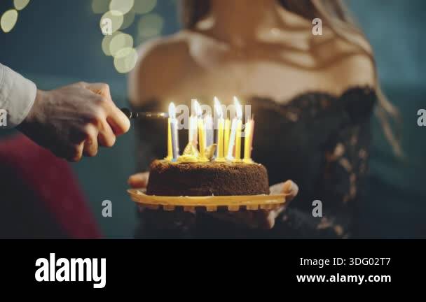 Festive sweet cake with candle which lighting on lighter, burner or ...
