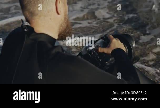 Professional freediver photographer sitting with his camera. Freediving ...