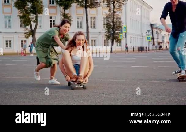 Cool Young Girls and Guy Longboards and Skateboards Through Stylish Hip ...