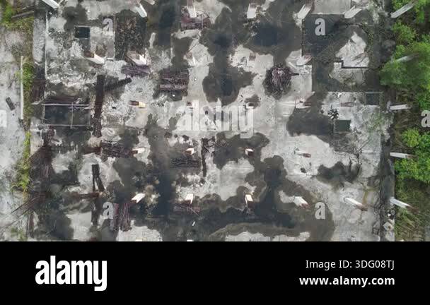 A large area of concrete with a lot of debris and dirt. There are many ...