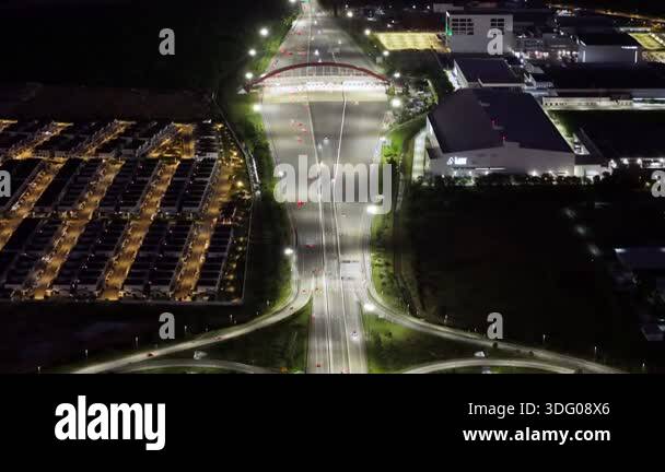 A street with a lot of cars and a building in the background. The ...