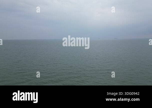 The ocean is calm and the sky is cloudy. There is no land visible in ...