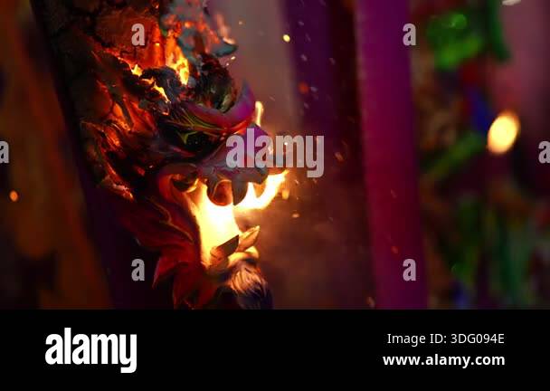 A dragon with fire on its face. The dragon is on a purple background ...