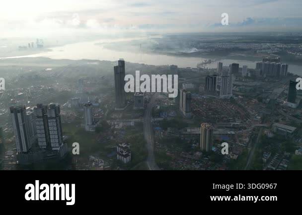 A city with a river in the background. The sky is cloudy and the city ...
