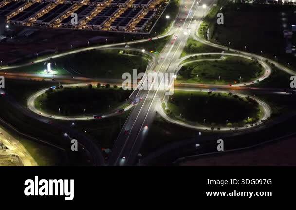 A highway with a large round curve in the middle. There are many cars ...