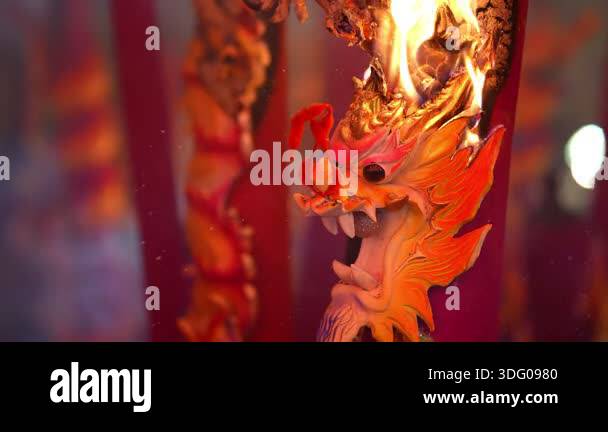 A dragon is on a red object with fire coming out of it. The dragon has ...