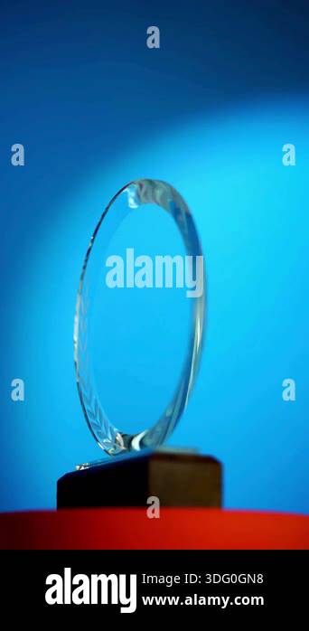 Rotating clear round crystal trophy with etched laurel wreath design on ...