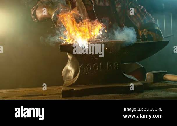 Cinematic close-up of blacksmith forging glowing hot iron on anvil with ...