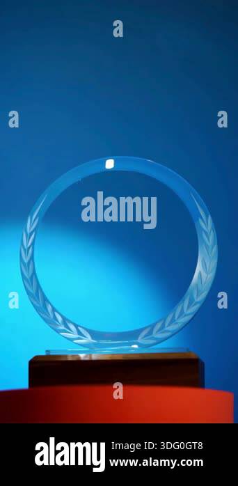 Circular crystal glass trophy with etched laurel wreath design on ...