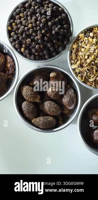 Assorted organic indian spices including black pepper fennel and nutmeg ...