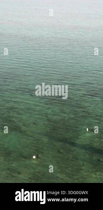 High angle aerial shot of extremely clear, turquoise colored ocean ...
