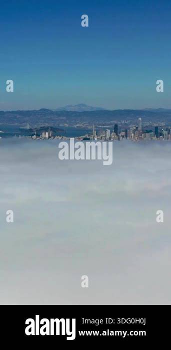 High aerial view of the San Francisco skyline peaking out above a vast ...