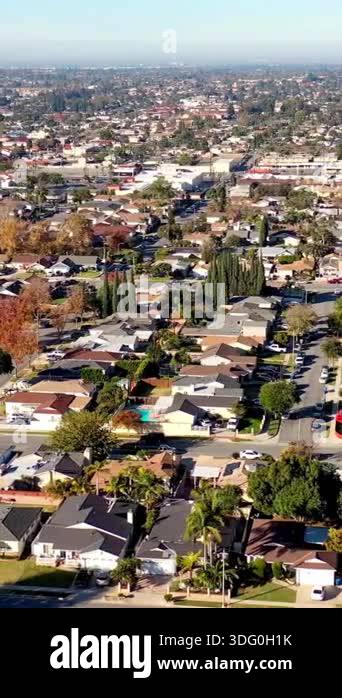High aerial shot panning across a sprawling, dense suburban ...