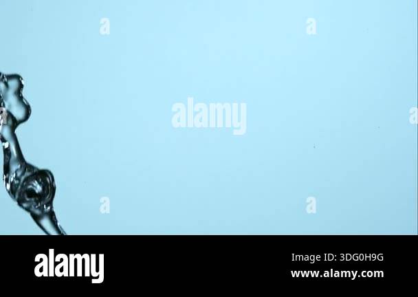 High speed footage showing clean water pouring and splashing as it ...