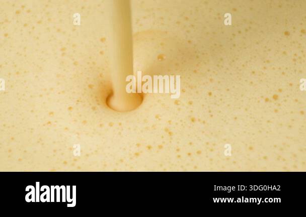 Texture of smooth creamy batter flowing down slow motion Stock Video ...