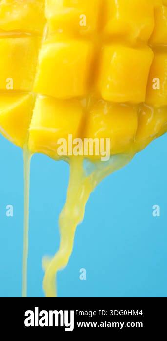Slow motion macro of fresh mango juice flow on fresh fruit pulp Stock ...