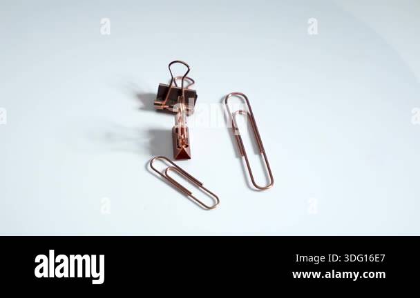 Paper clips and binder clips. Close-up video of metal paper clips and ...