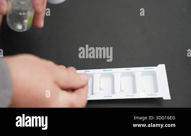 Weekly pill organizer on table. Video of a weekly pill organizer with ...