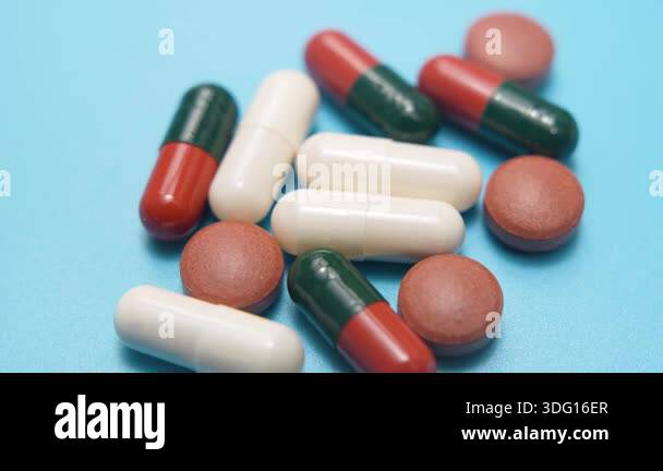 Pills on blue background. Macro video of assorted pills and capsules on ...