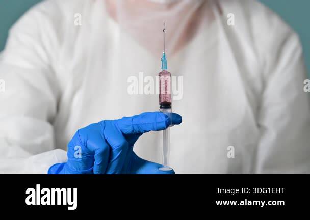 Female doctor injecting syringe in air closeup Stock Video Footage - Alamy