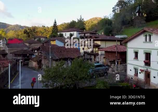 a drone video rising up during sunset in a Spanish town in Asturias ...