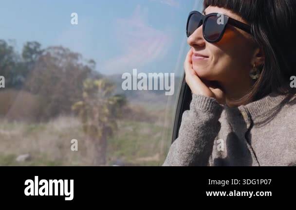 A train ride. A young woman rides on a train, admiring the beautiful ...