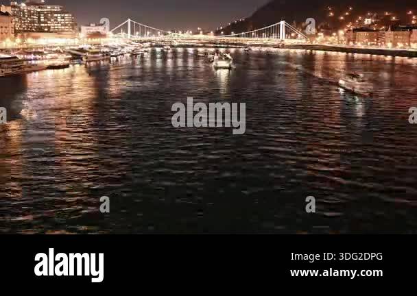 Night timelapse footage of river traffic with illuminated boats and ...
