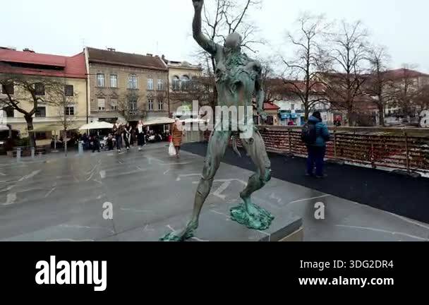 A detailed bronze sculpture depicting a Water Genius figure stands in a ...