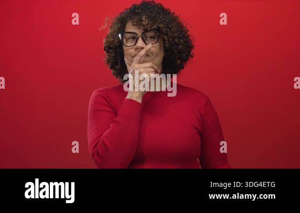 Hispanic middle aged woman wearing glasses and a red sweater with hand ...