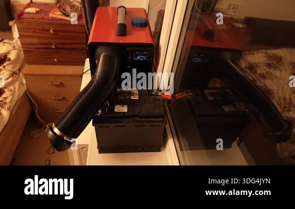 Red Electric heater connected to battery near window Stock Video ...