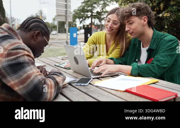Student friends working together on laptop preparing for exams and ...