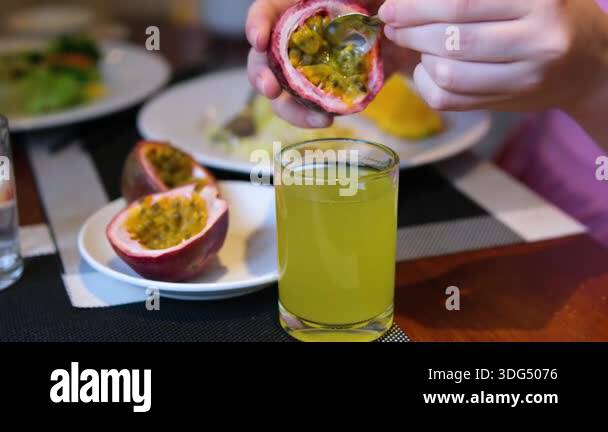 Passionfruit juice preparation Person preparing fresh passion fruit ...