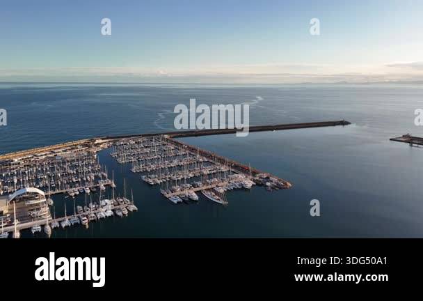 Aerial view of marina harbor with yachts and boats protected by ...