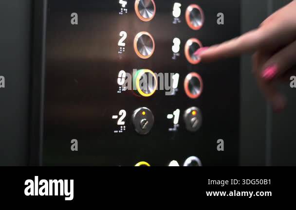 Close up of a person pressing elevator button on modern lift control ...