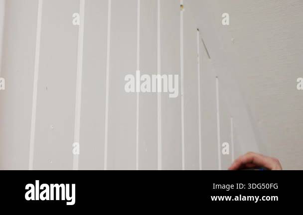 Hands measuring a wall with a tape measure during a home improvement ...