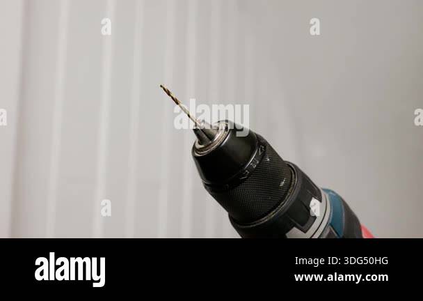 Testing a power drill before use to ensure proper function, preparing ...