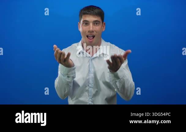 Man with open palms gesture and eager expression in a bright blue ...