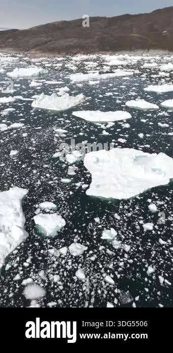Aerial advance over thousands of floating ice pieces with barren ...