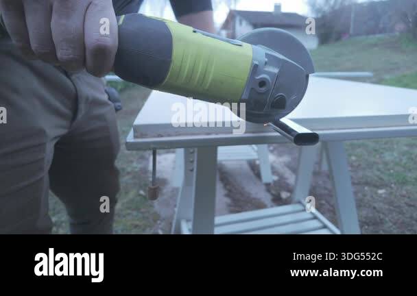 Lateral shot showing polisher right side cutting aluminum rod as sparks ...