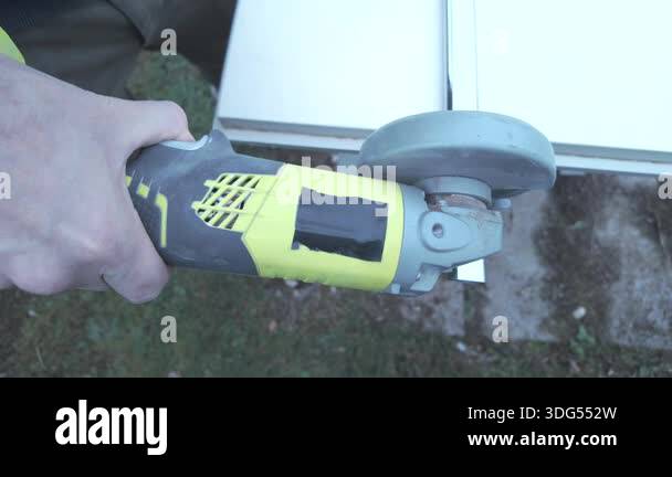 Overhead angle showing polisher disc cutting aluminum rod with sparks ...