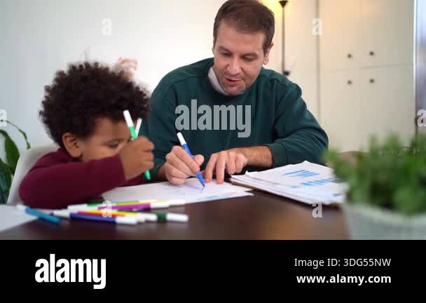 Multiracial father and son enjoying a creative moment together, drawing ...