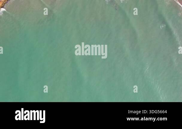 Turquoise ocean water reveals a tropical coastal town with a wooden ...