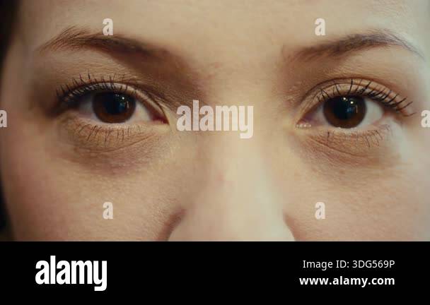 Extreme close-up of a womans eyes looking ahead and blinking, detailed ...