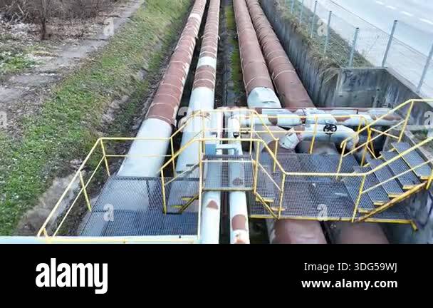 Industrial pipes showing gradual transition from rusted brown to faded ...