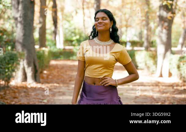 Happy young indian woman wearing a traditional sari and jewelry smiling ...