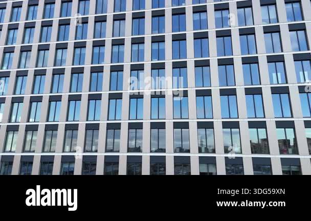 Modern office building exterior showcasing a series of large windows ...