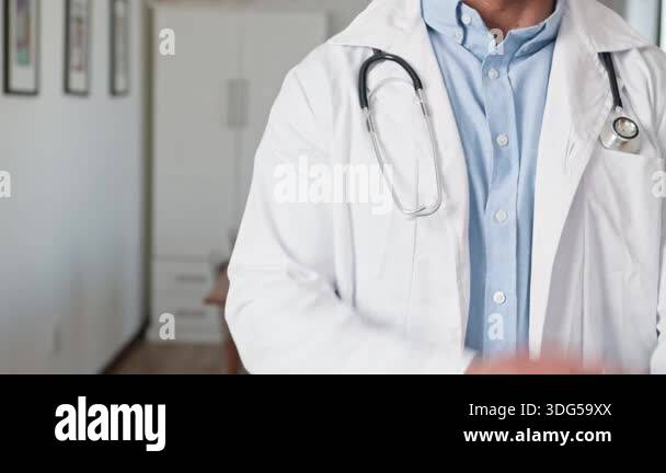 A confident medical doctor in a white lab coat, wearing a stethoscope ...