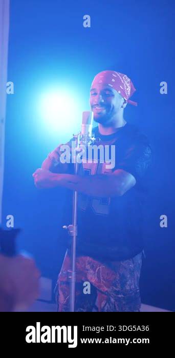 Young male artist with a red bandana rapping and gesturing ...