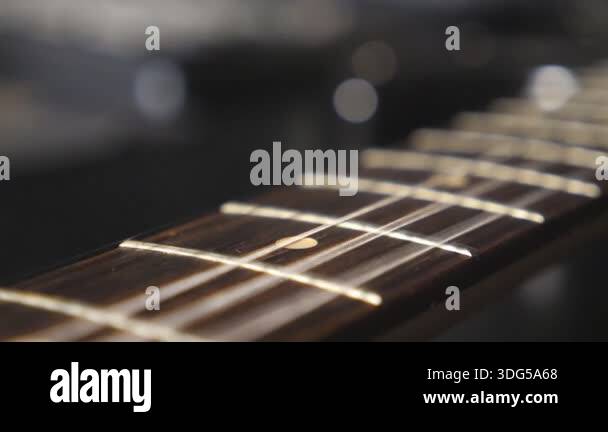 Dolly shot of chords being strummed and vibrating during playing. Close ...